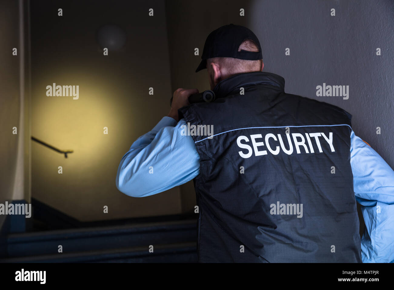 Rear View Of A Male Security Officer With Flashlight Stock Photo - Alamy