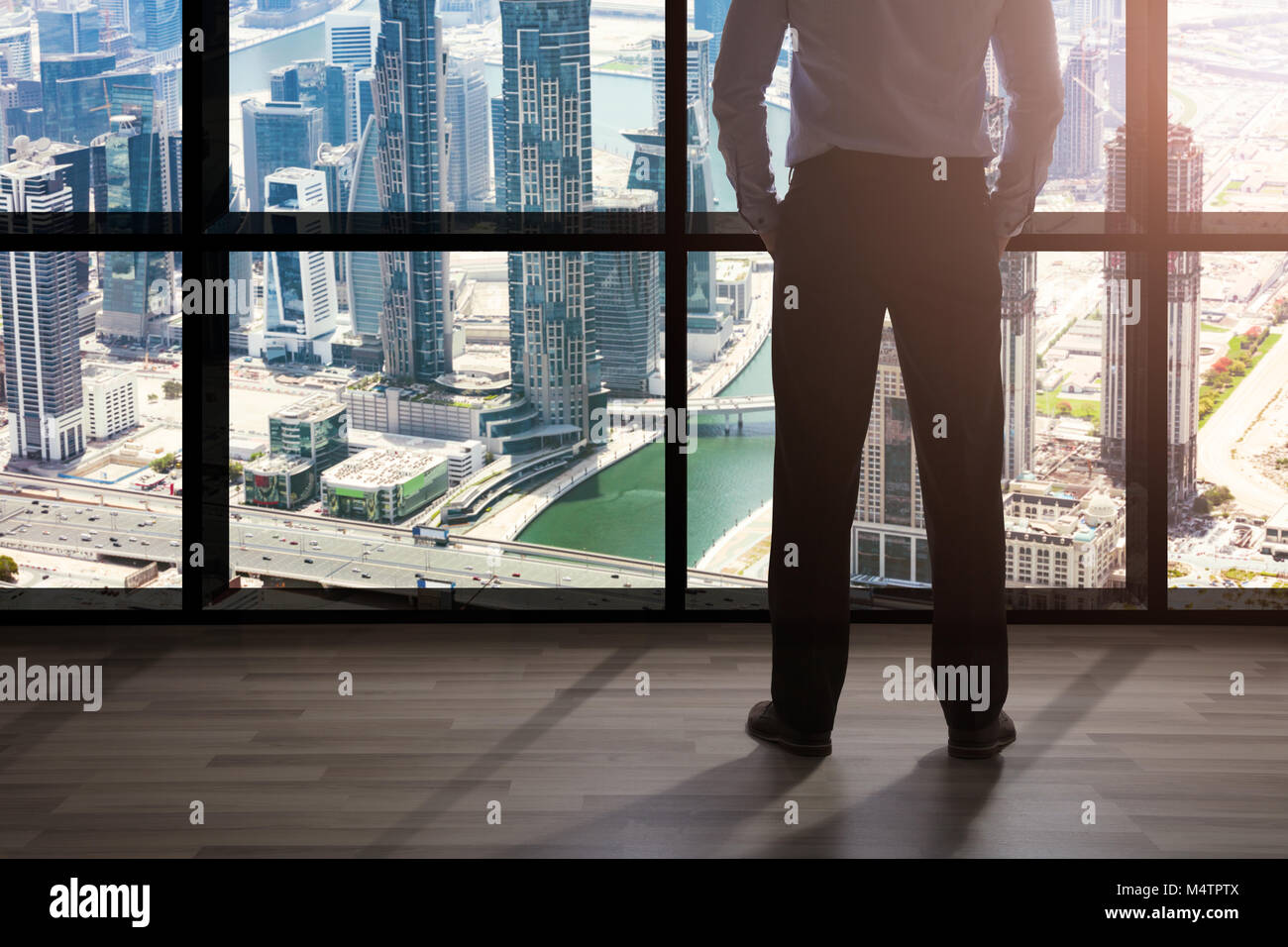 Businessman Standing At The Large Window Of A High Office Overlooking ...