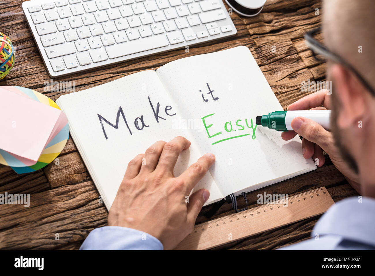 Businessman Writing Make It Easy Text On Notebook With Green Marker ...