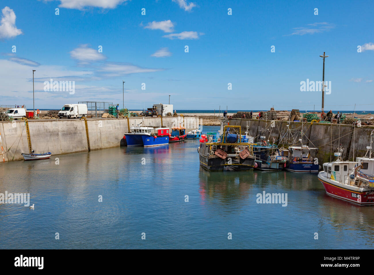 Views of Seahouses harbour in Northumberland under a sunny blue sky,UK ...