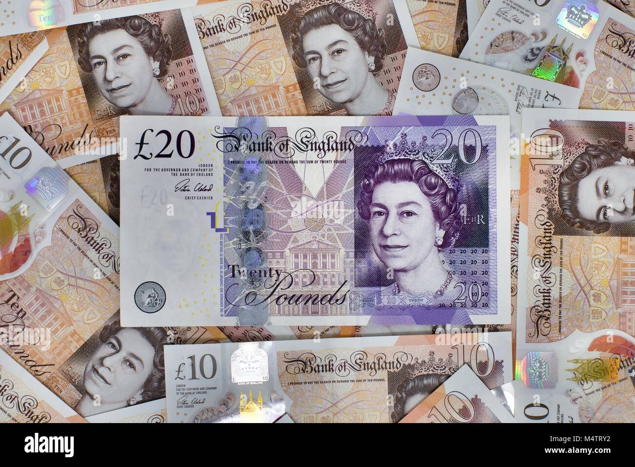 Twenty pound banknote with the new plastic ten pound banknotes in the ...