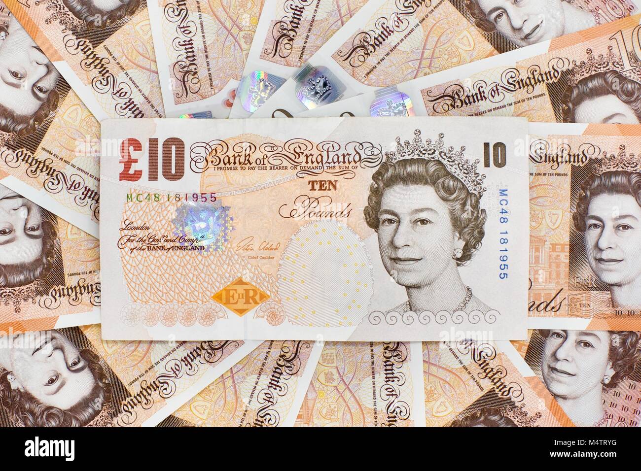 A old fashioned £10 banknote with the new polymer £10 banknotes in the ...