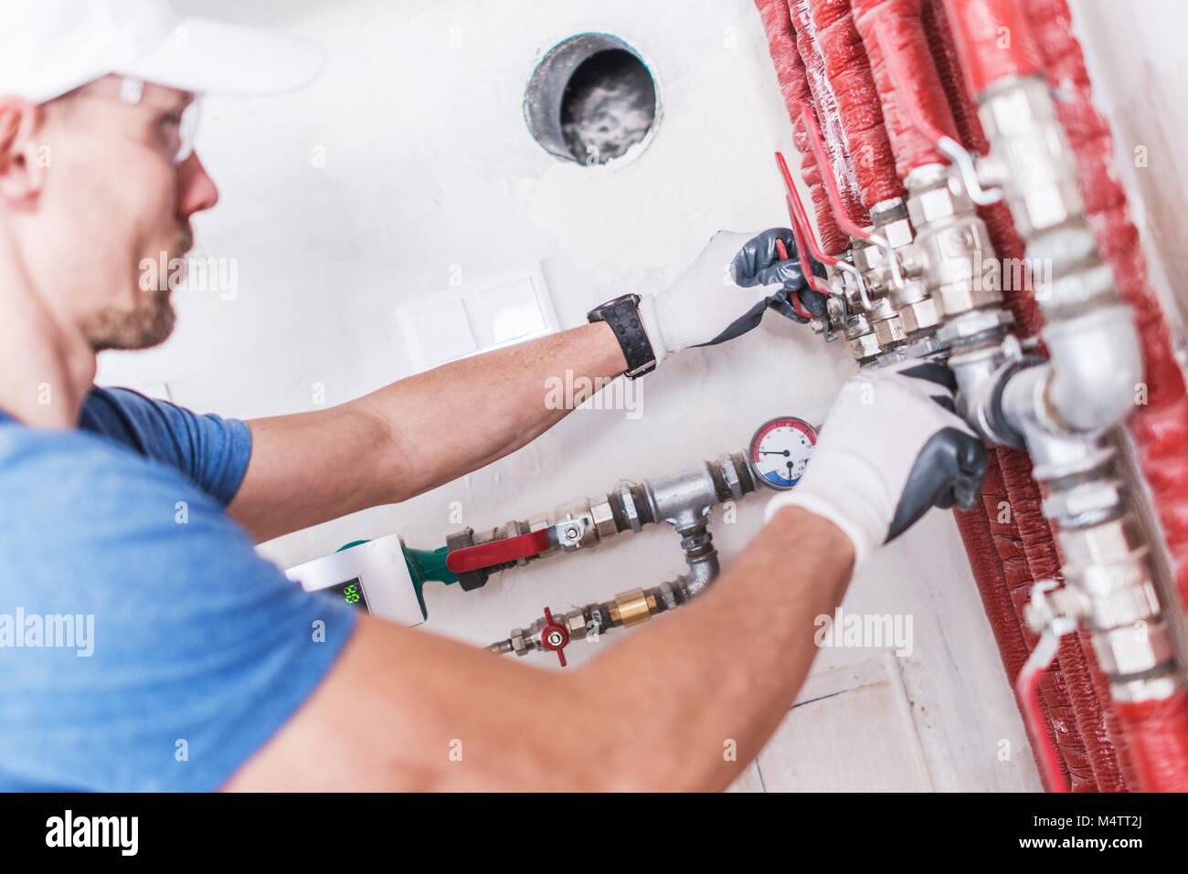 Professional Plumber Work. Caucasian Worker Checking on Water Valves ...
