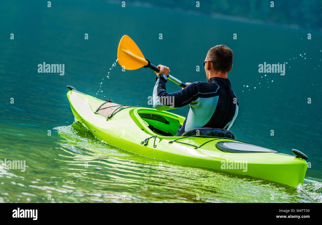Recreational Kayak Trip. Caucasian Men in the Kayak on the Scenic Lake ...