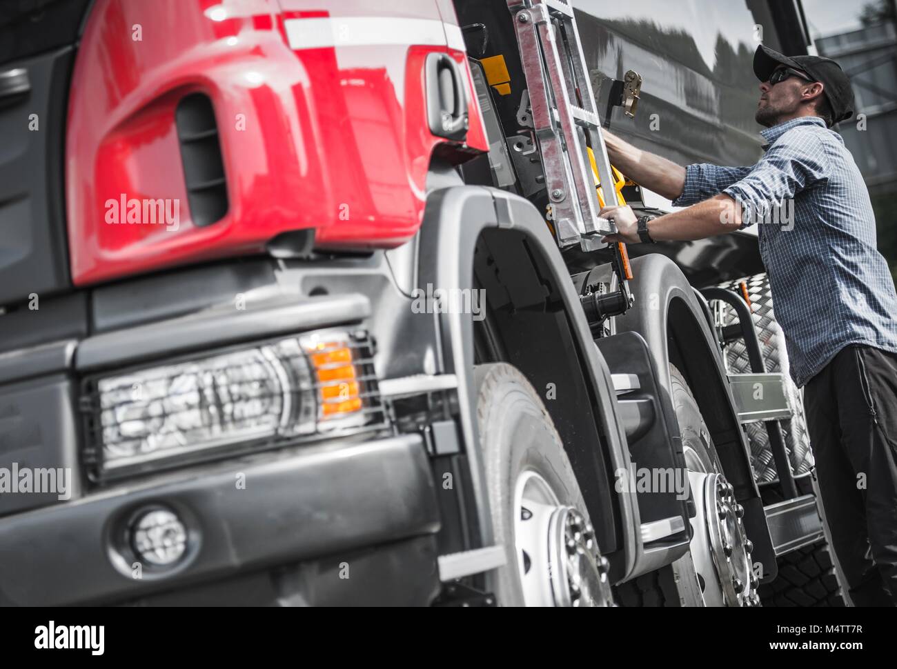 Caucasian Truck Driver Final Load Check Before Hitting the Road. Heavy ...