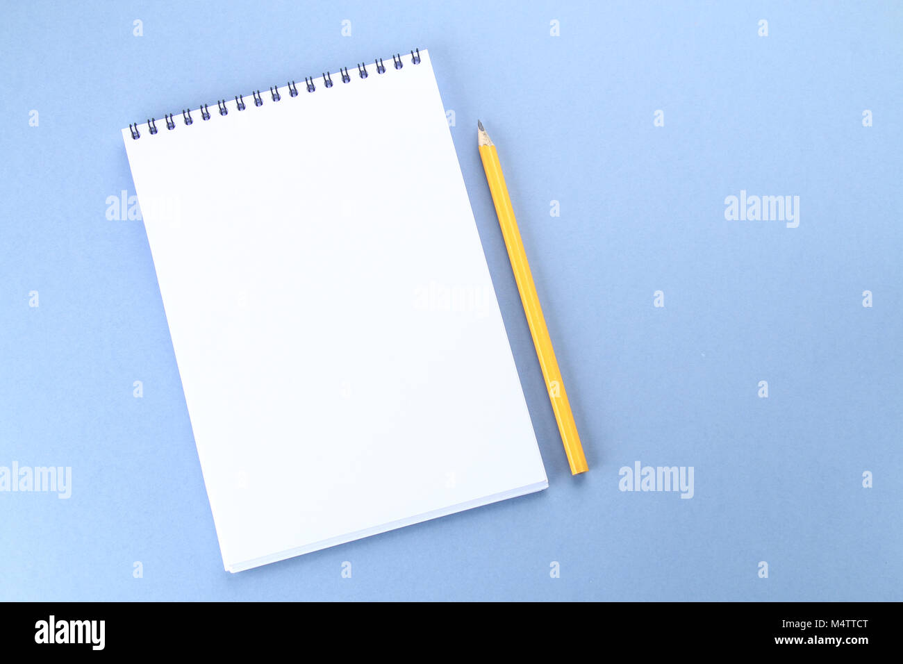 Top view image of open notebook with blank pages and coffee on blue ...