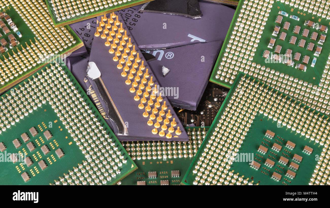 Broken obsolete processor among the new modern ones. Heap of computer ...