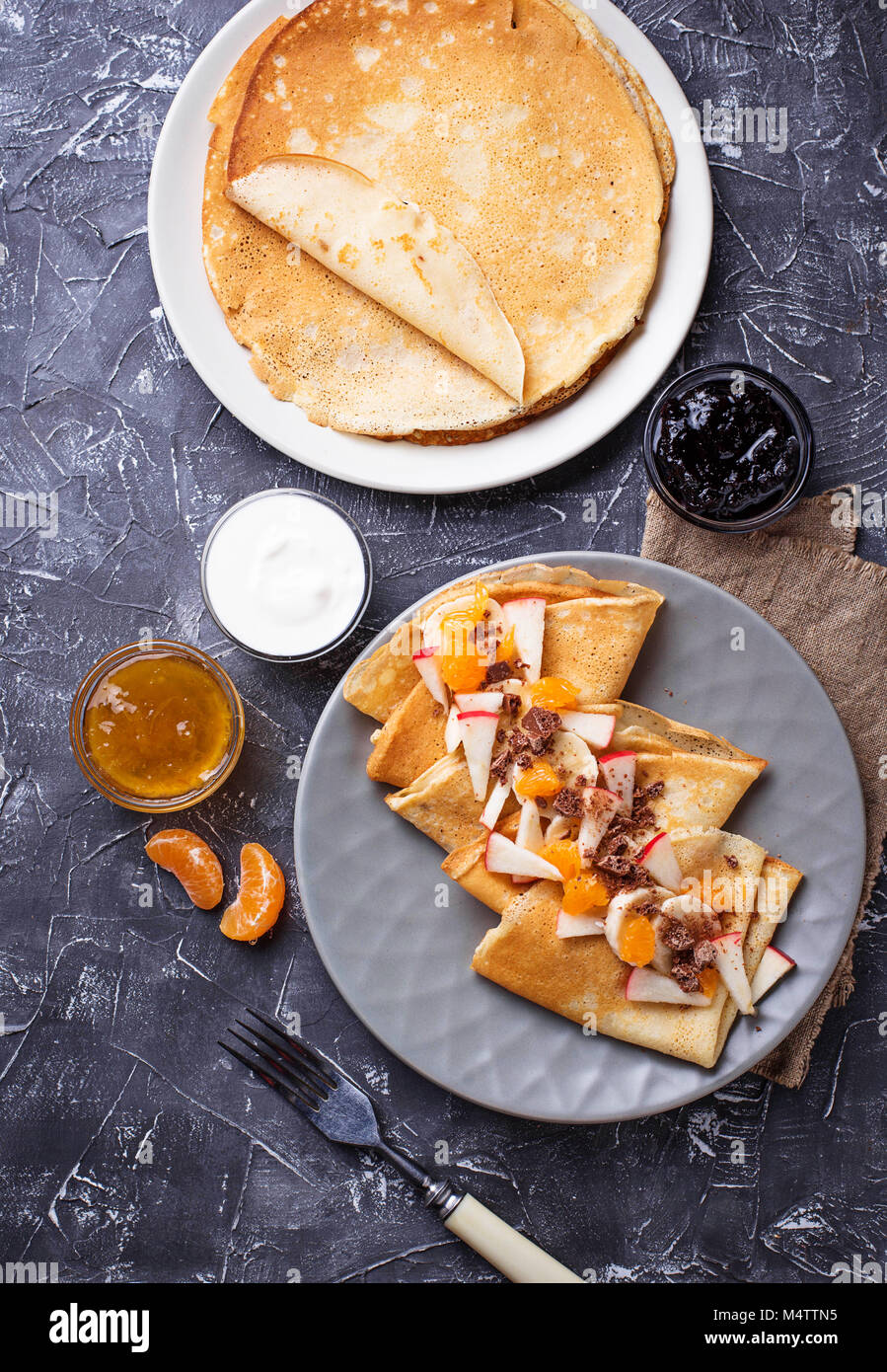 Pancakes crepes with different fruits and chocolate Stock Photo - Alamy