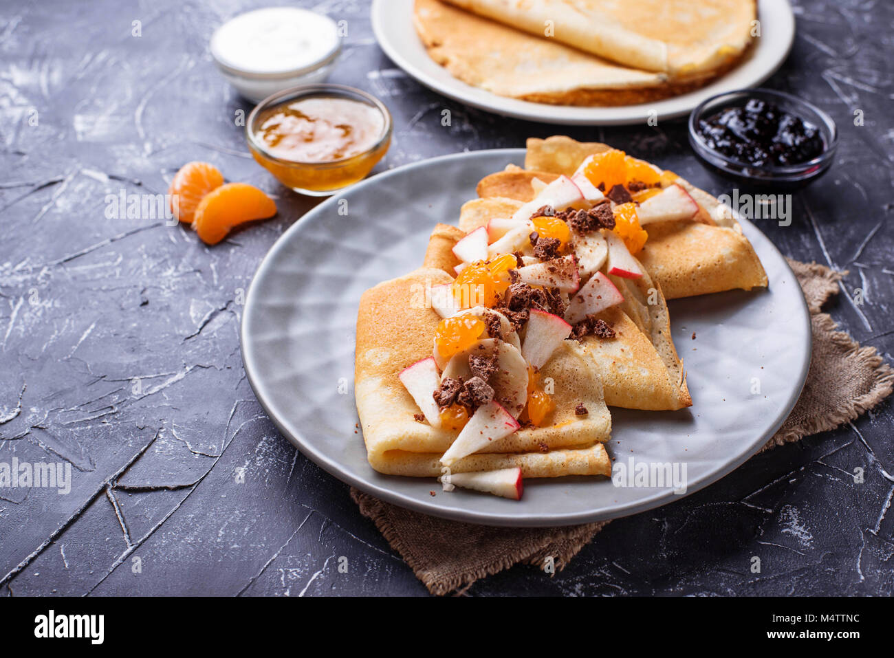 Pancakes crepes with different fruits and chocolate Stock Photo - Alamy