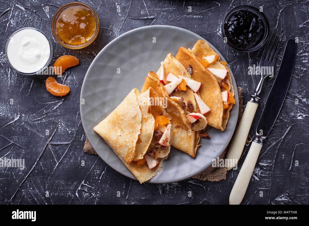 Pancakes crepes with different fruits and chocolate Stock Photo - Alamy