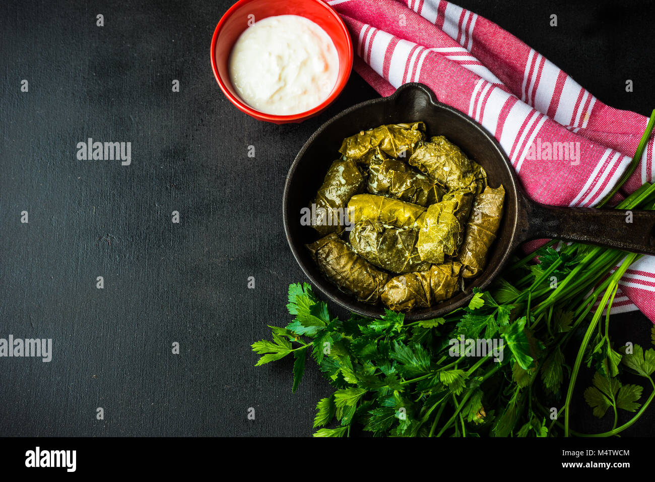 Traditional georgian dolma in grape leaves on rustic wooden table with ...