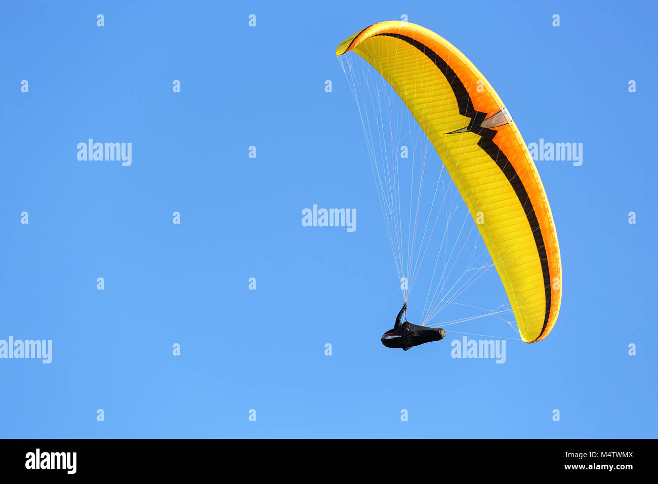 Sky diver with yellow orange parachute floating in the air Stock Photo ...
