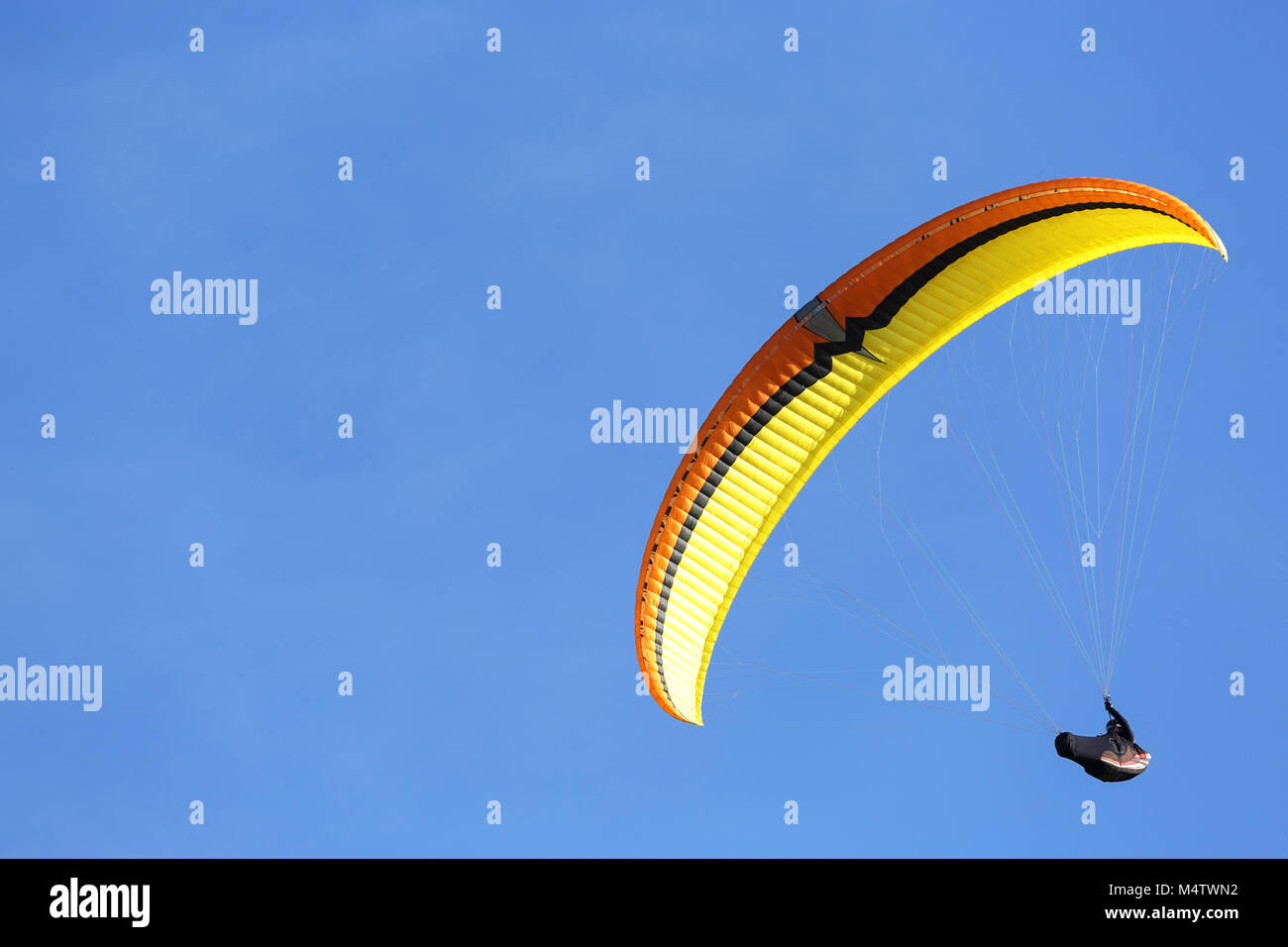 Sky diver with yellow orange parachute floating in the air Stock Photo ...