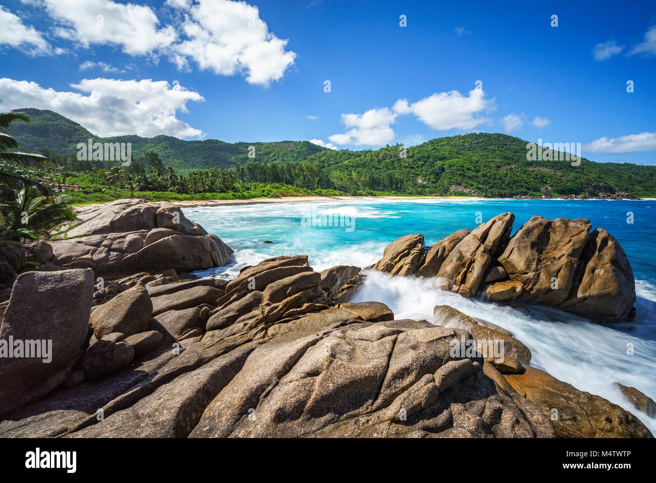 Splashing water withe big water fountains on a wild tropical beach with ...
