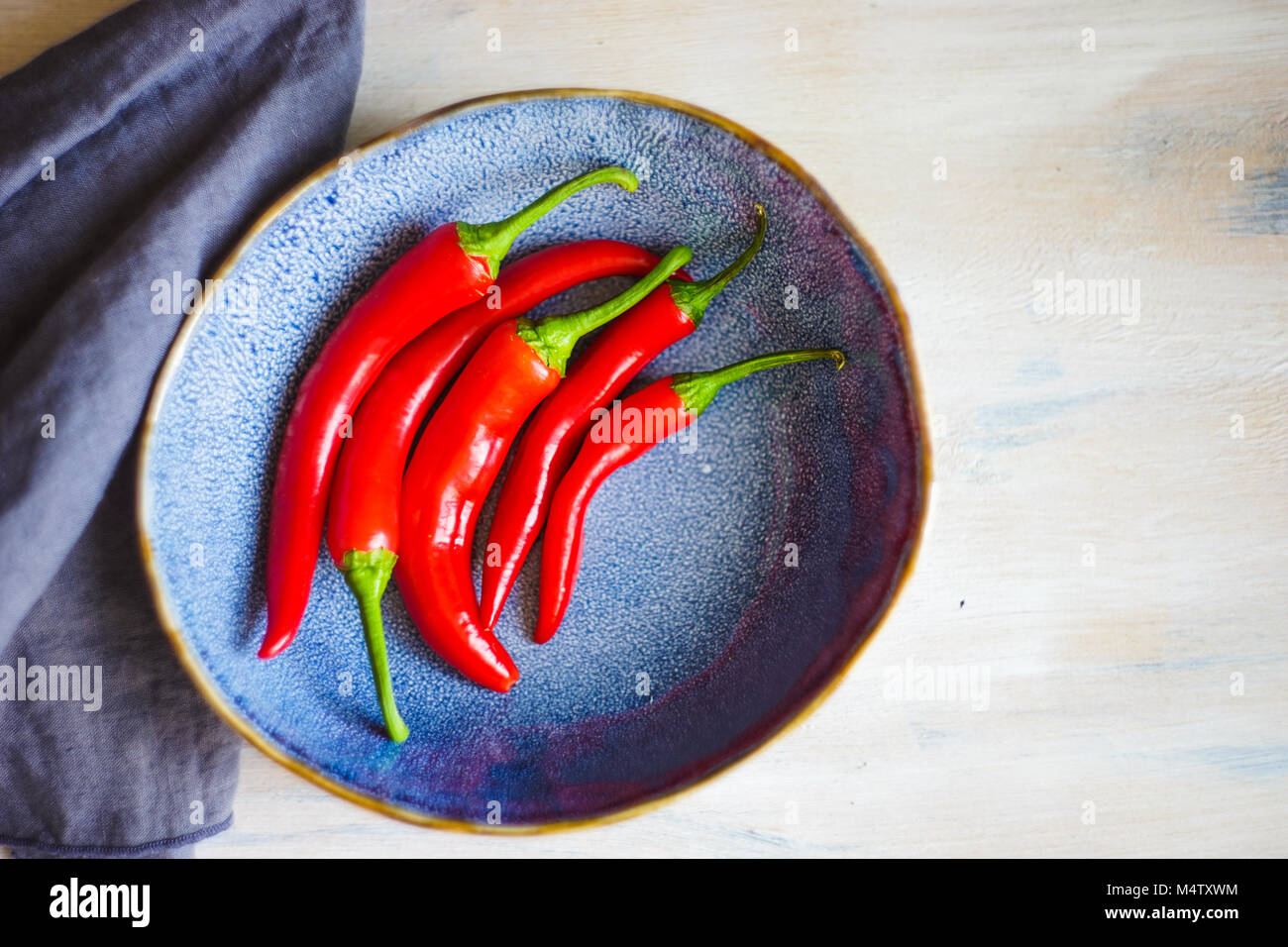 Table setting with red hot chili pepper on dark wooden table with copy ...
