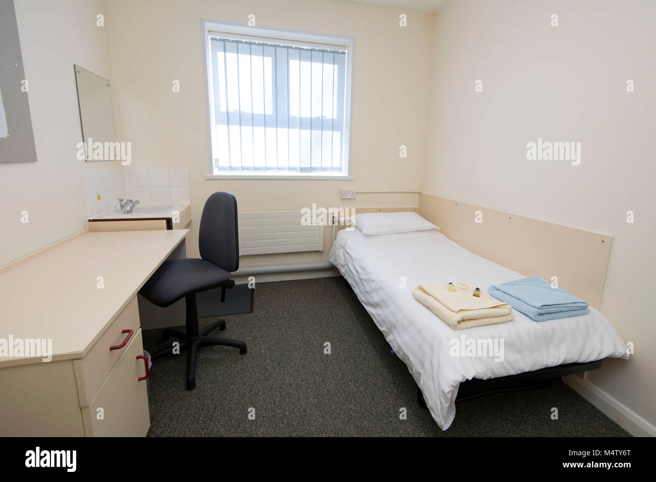 Small bedroom and study student accommodation area in university halls ...