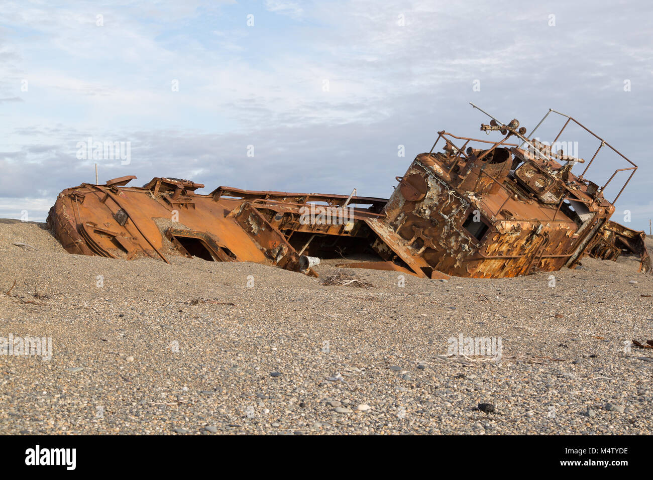 Old rusty boat in sand and a pebble on seacoast Stock Photo - Alamy