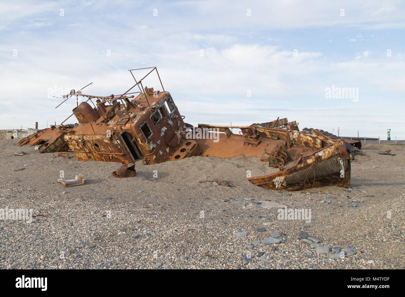 Old rusty boat in sand and a pebble on seacoast Stock Photo - Alamy