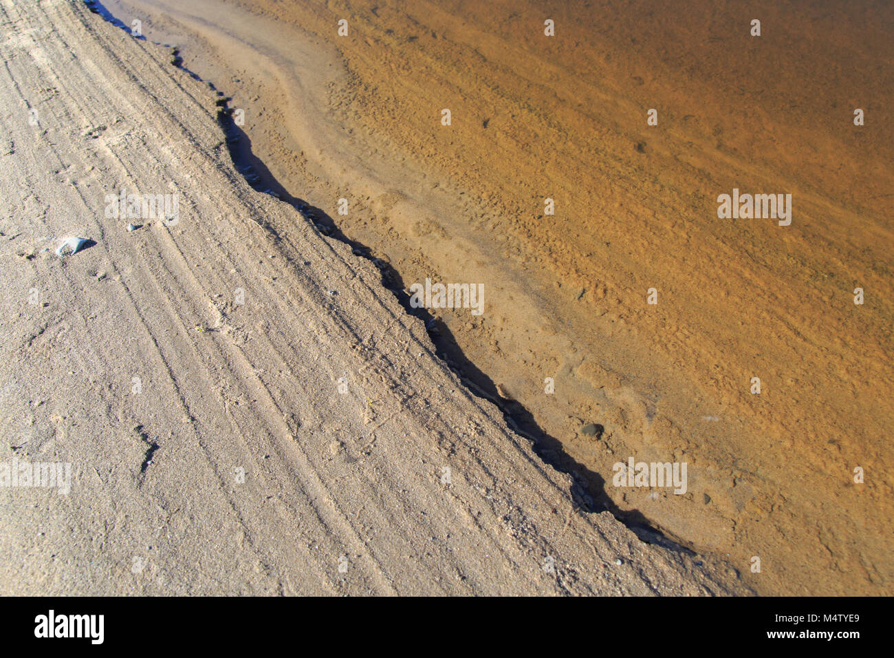 Sandy coastal strip with sharply outlined shades from roughnesses of ...