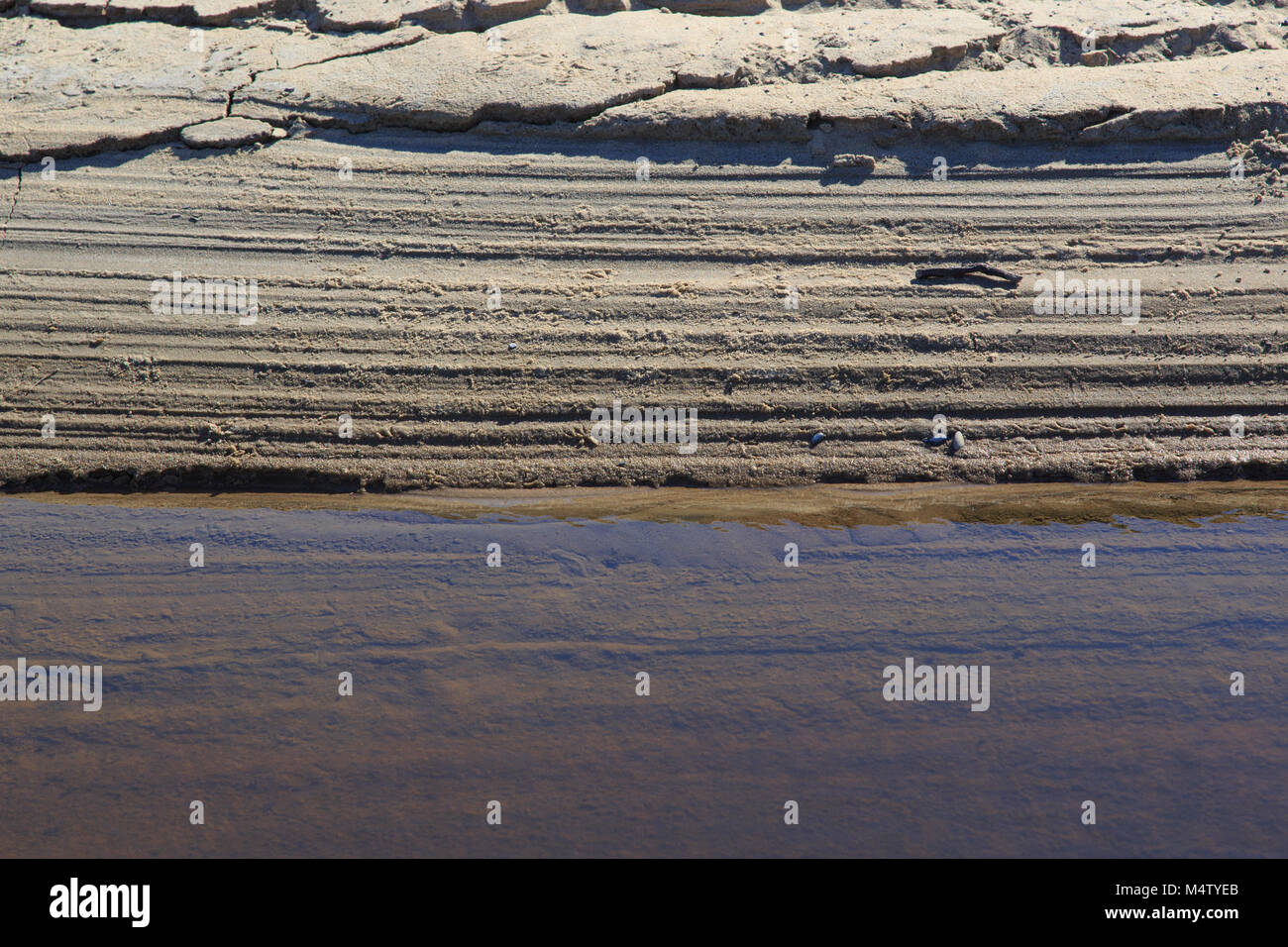 Sandy coastal strip with sharply outlined shades from roughnesses of ...
