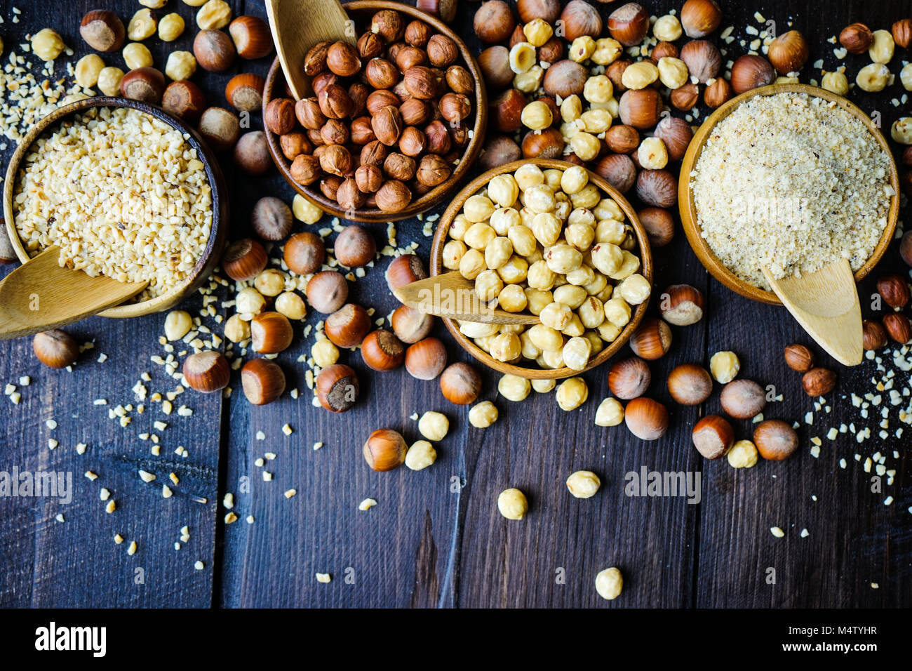 Different types of hazelnuts on dark wooden background with copyspace ...