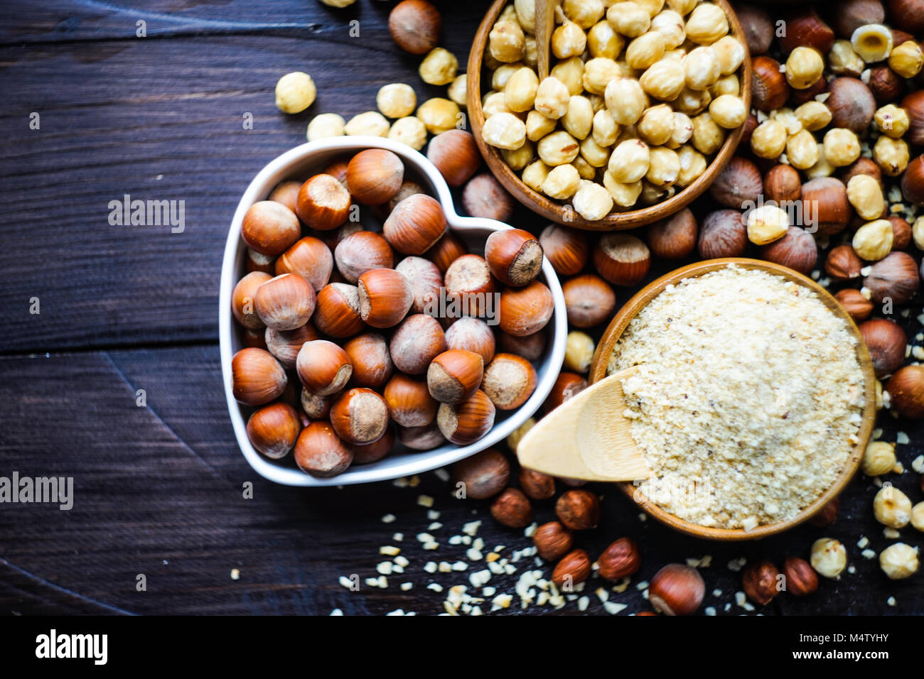 Different types of hazelnuts on dark wooden background with copyspace ...