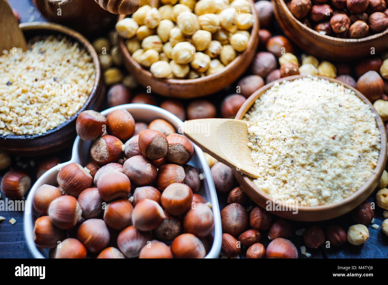 Different types of hazelnuts on dark wooden background with copyspace ...
