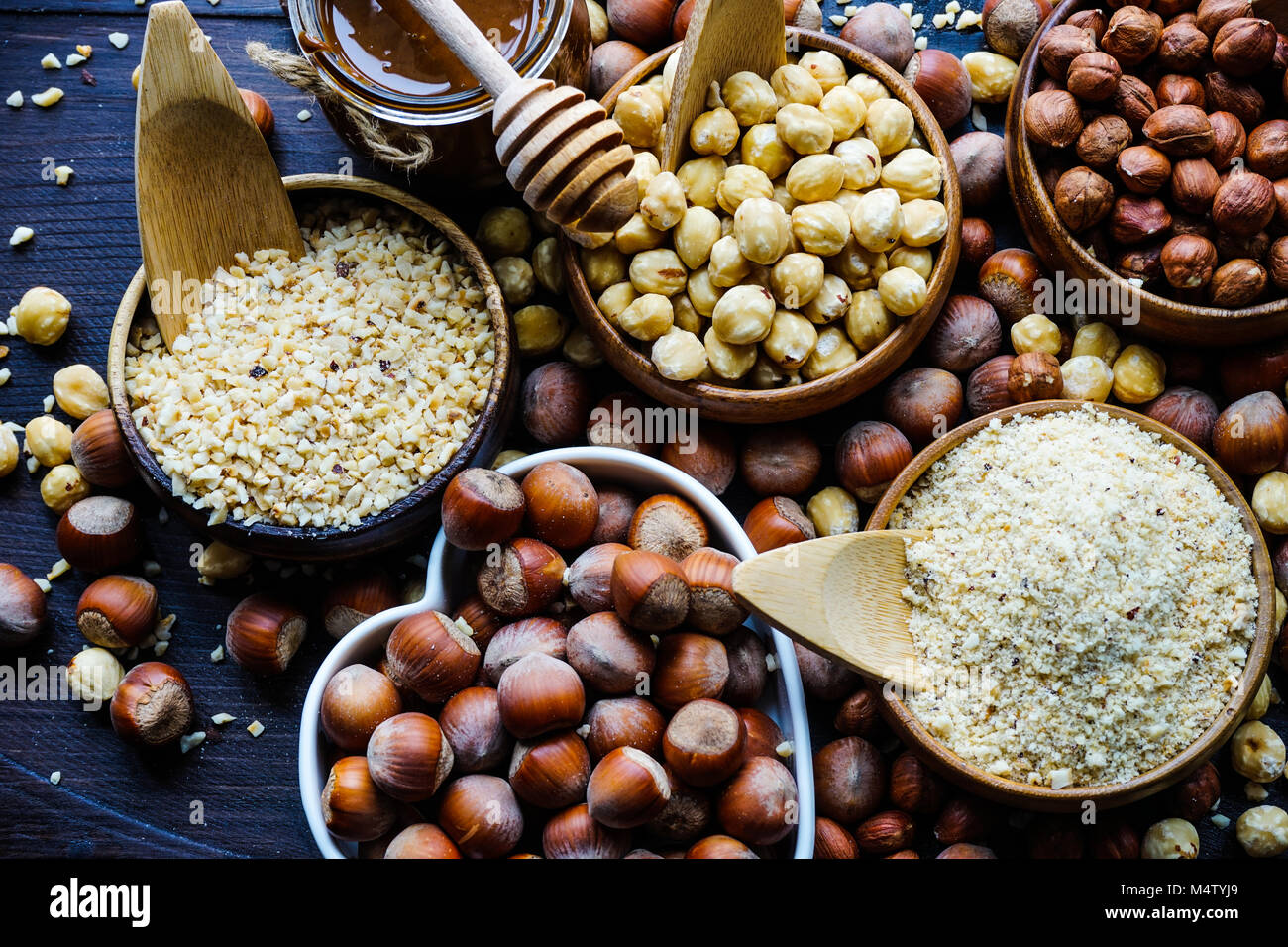 Different types of hazelnuts on dark wooden background with copyspace ...