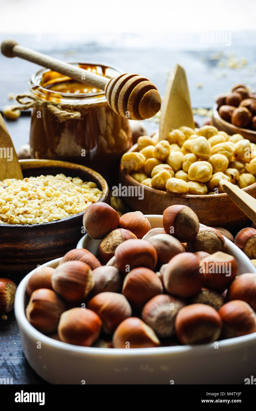 Different types of hazelnuts on dark wooden background with copyspace ...