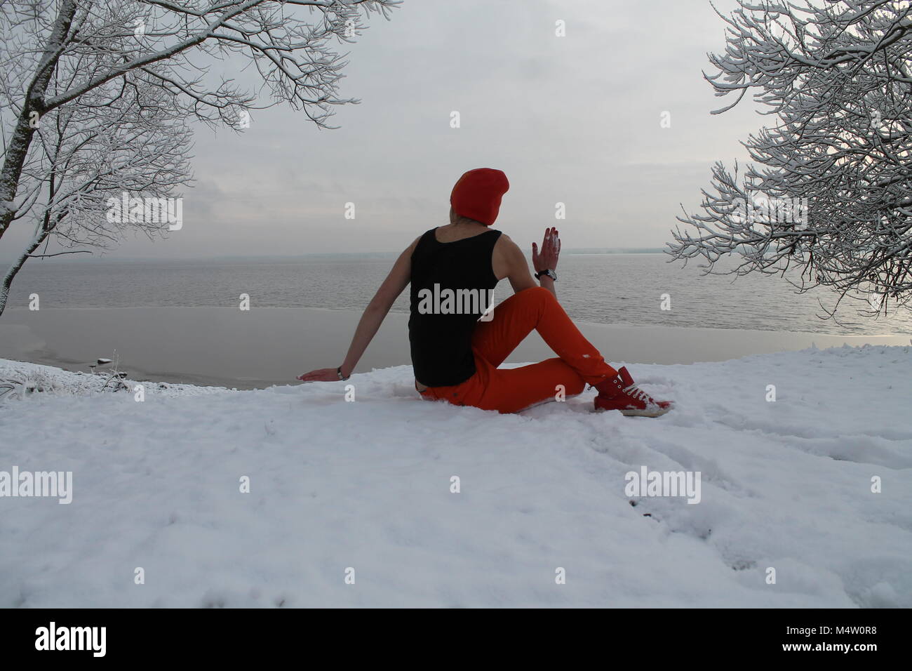beautiful flexible young woman made yoga morning poses in cold winter ...