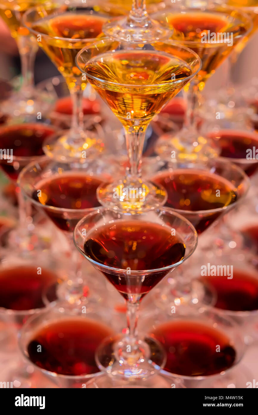 Pyramid of glasses for beverages, wine, champagne, red and yellow ...