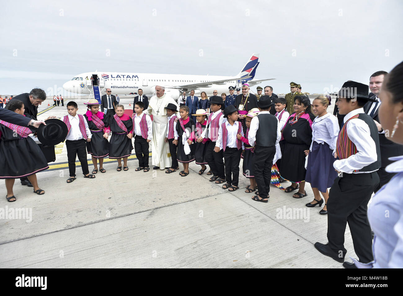 Pope Francis is welcomed on his arrival at the airport of Iquique ...