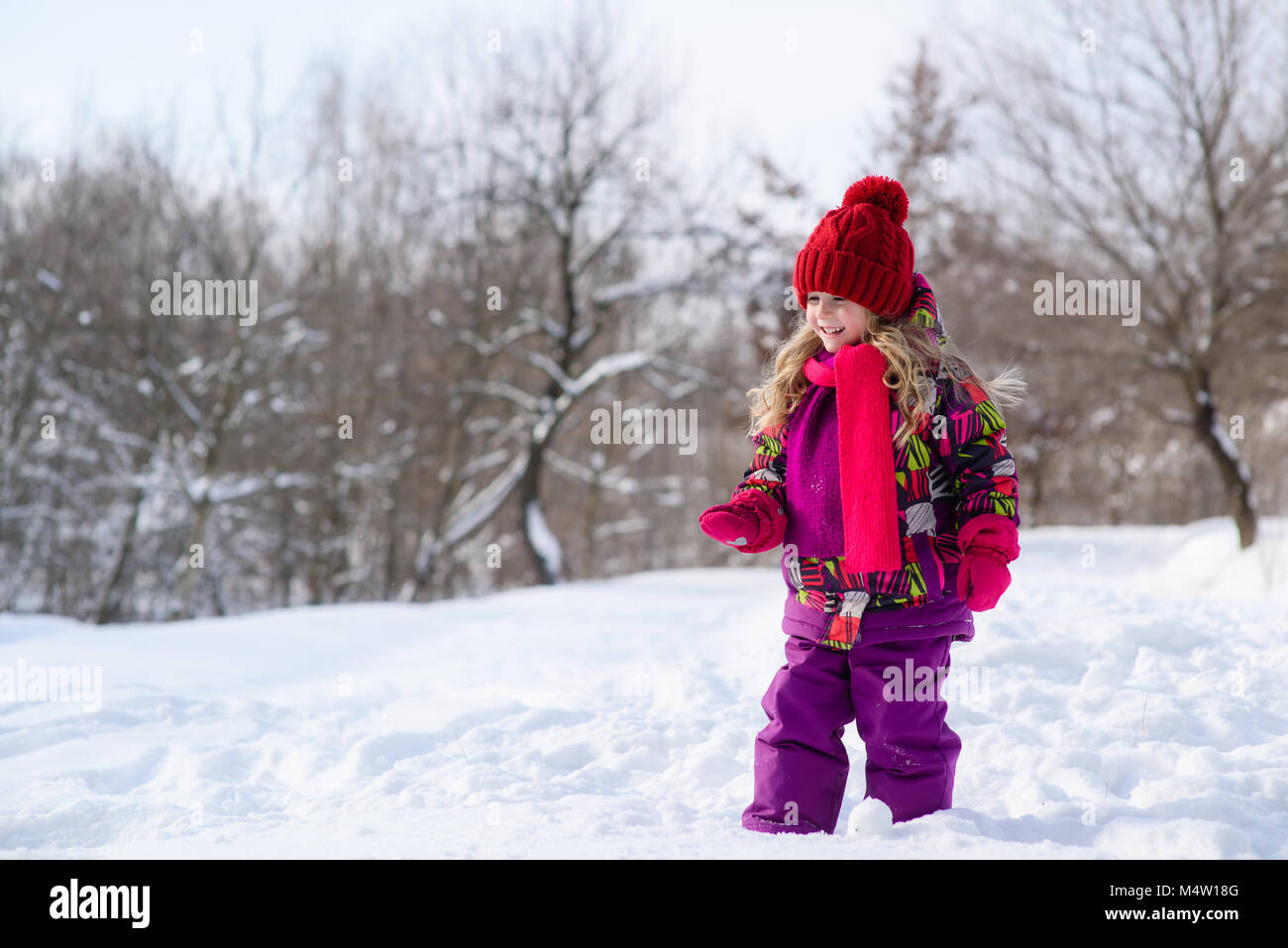 Little cute little girl on a snowy background Stock Photo - Alamy