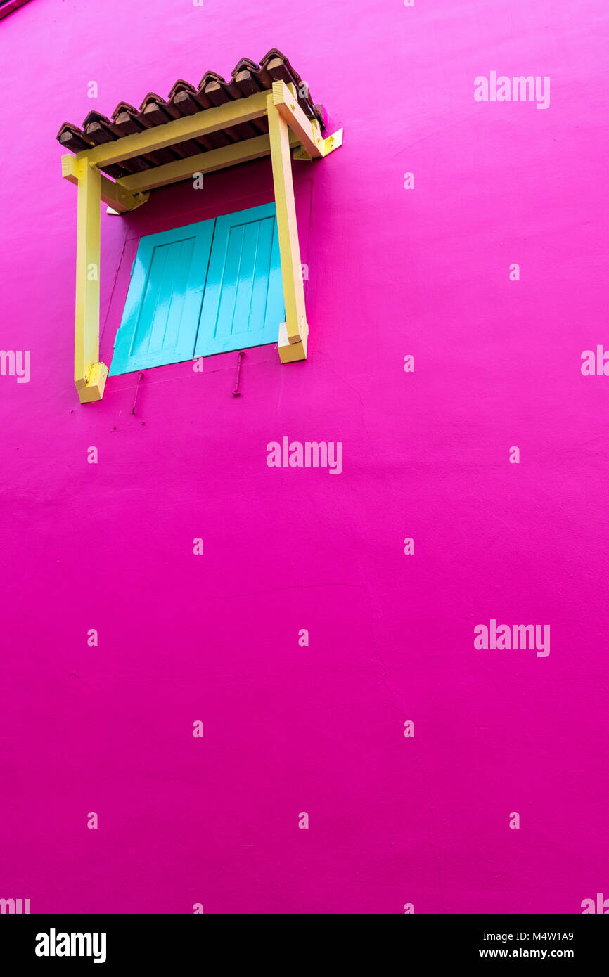 Pink wall with a small window with closed shutters and an awning Stock ...