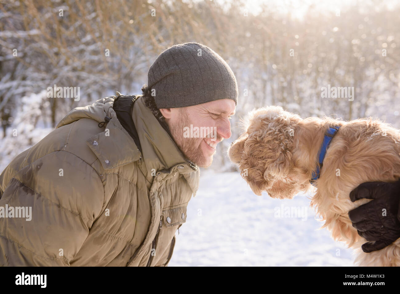 Man playing with cocker spaniel outdoors Stock Photo - Alamy