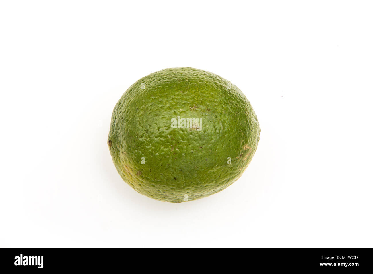 A picture of a single fresh green lime isolated on a white background ...