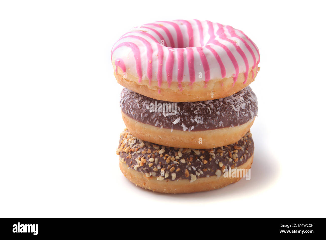 Assorted doughnuts in the glaze, colorful sprinkles and nuts on a white ...