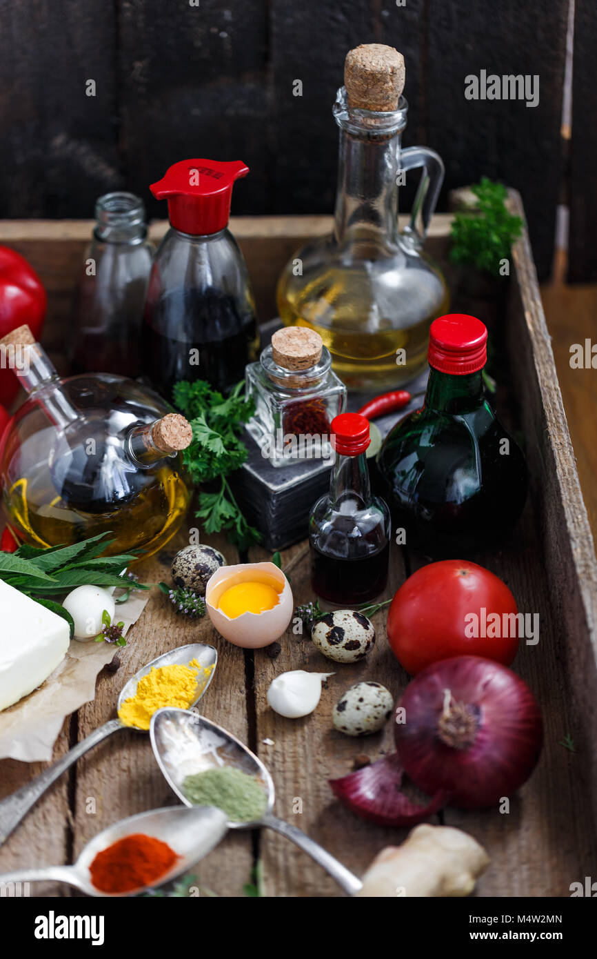 Big set of sauces and spices, with vegetables in a wooden box Stock ...