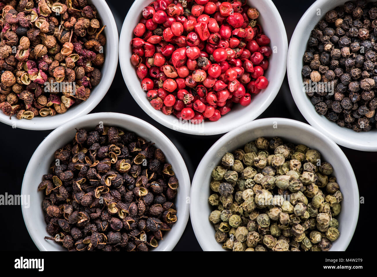 Five different pepper seeds in pots, oriental spices mix Stock Photo ...