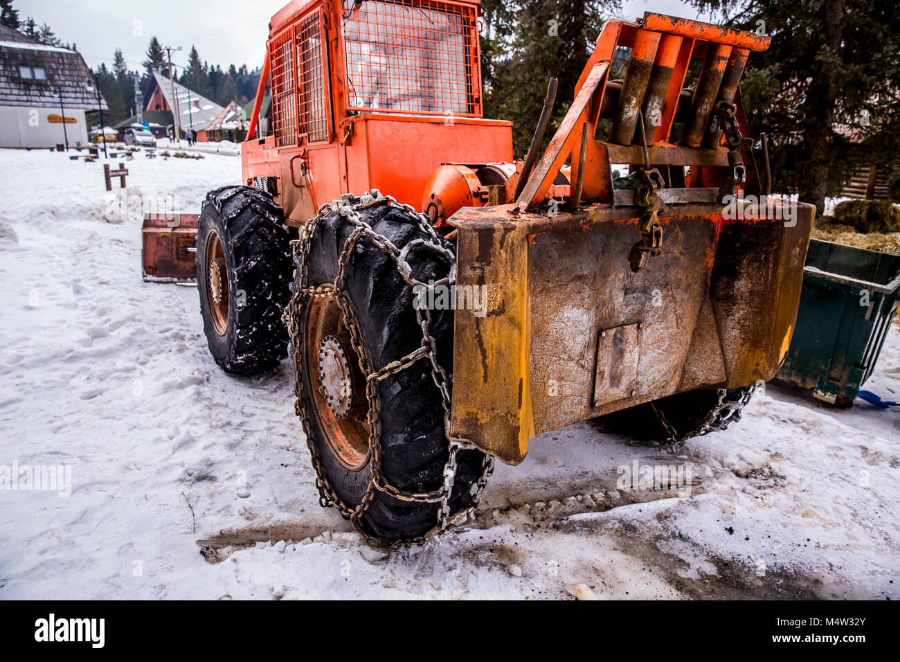 Logging machine giant wheels equipped with snow chains. Winter concept ...