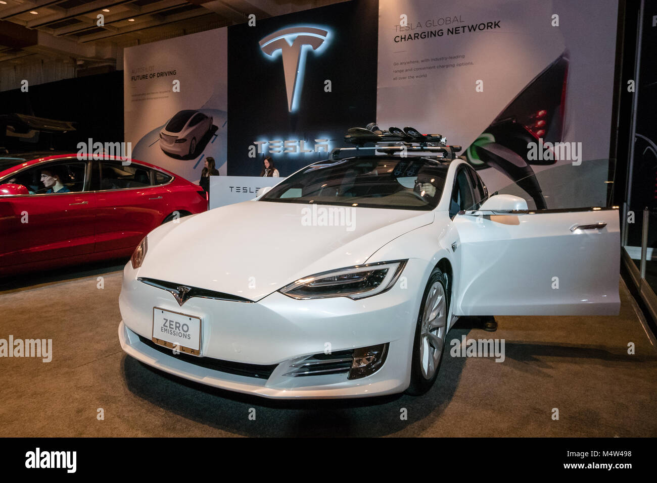 white tesla electric eco friendly sedan in a car show Stock Photo - Alamy