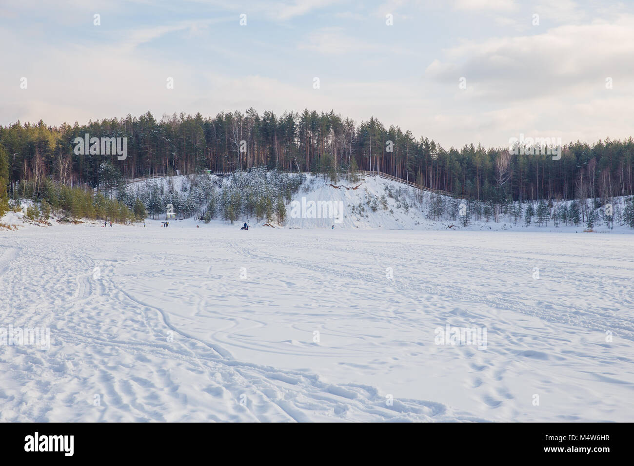 City Ogre, Latvia. Peoples and old sand quarry at city Ogre. Snow and ...