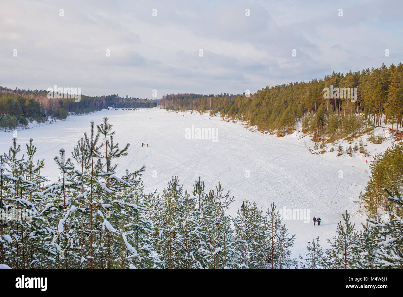 City Ogre, Latvia. Peoples and old sand quarry at city Ogre. Snow and ...