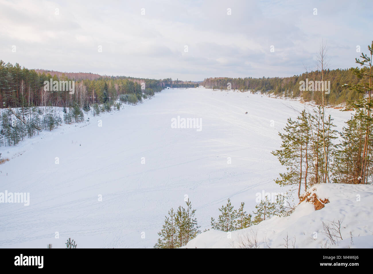 City Ogre, Latvia. Peoples and old sand quarry at city Ogre. Snow and ...