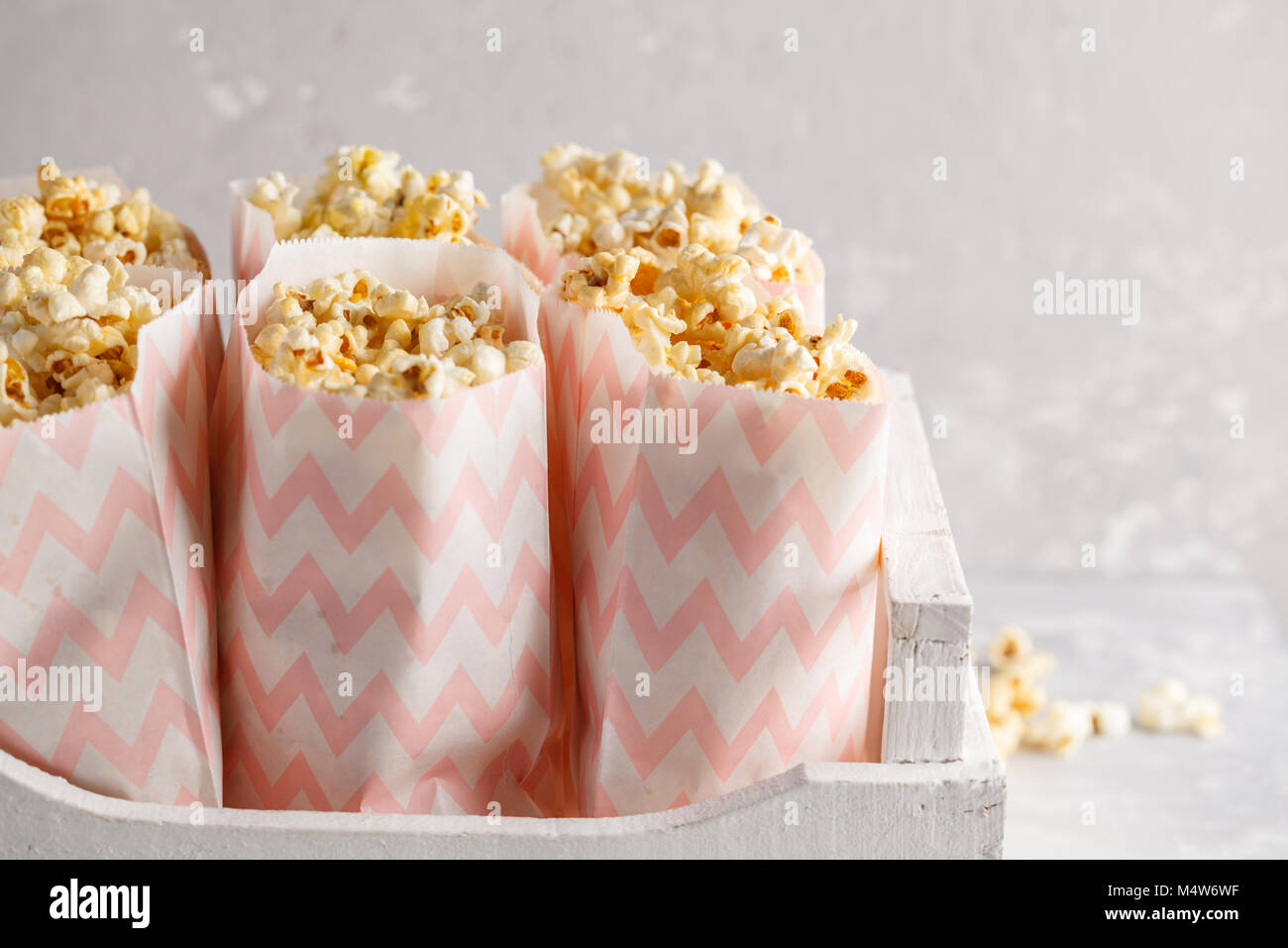 Golden caramel pop corn in paper bags in a white wooden box Stock Photo ...