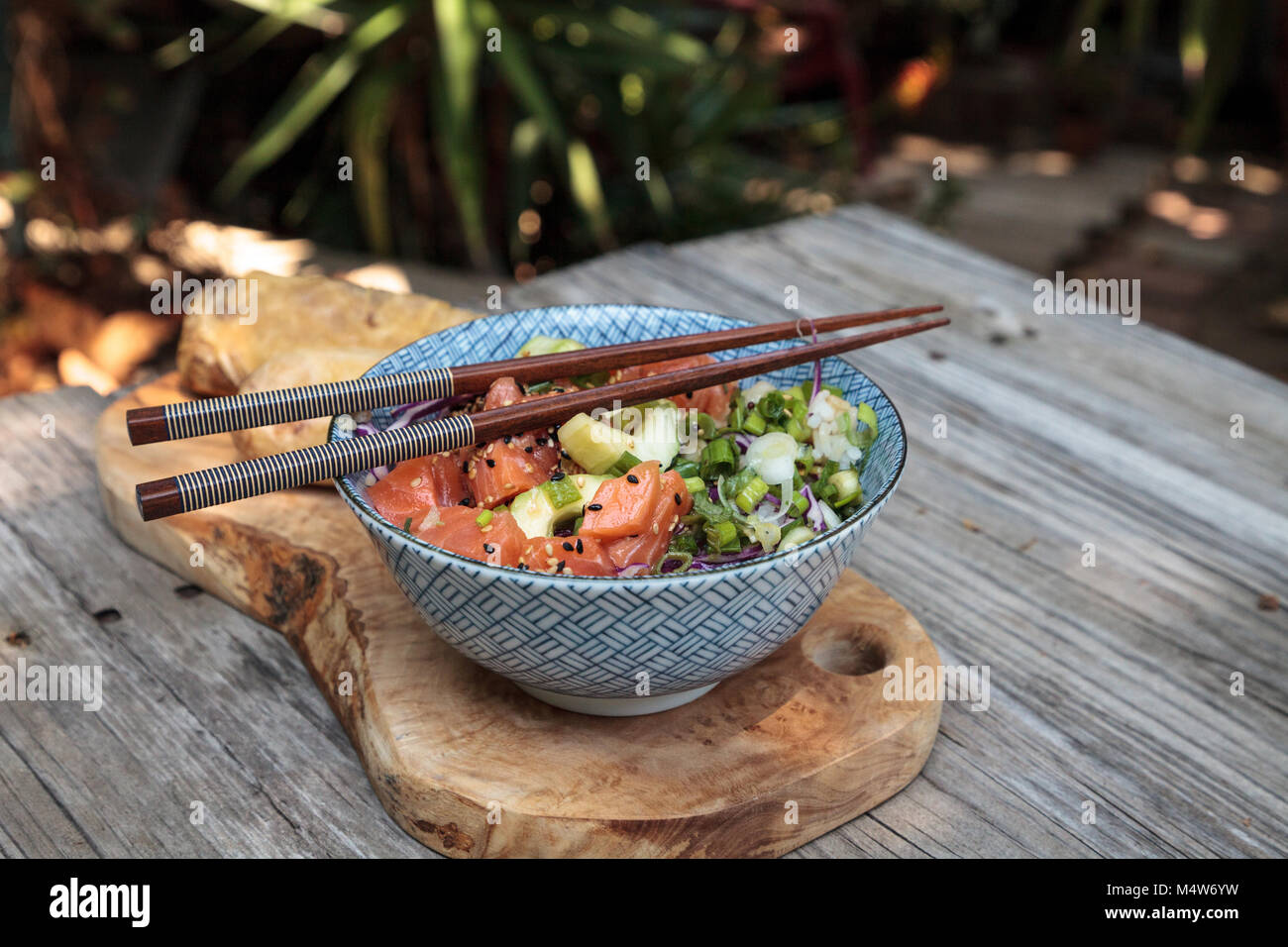 Raw salmon poke bowl with rice Stock Photo - Alamy
