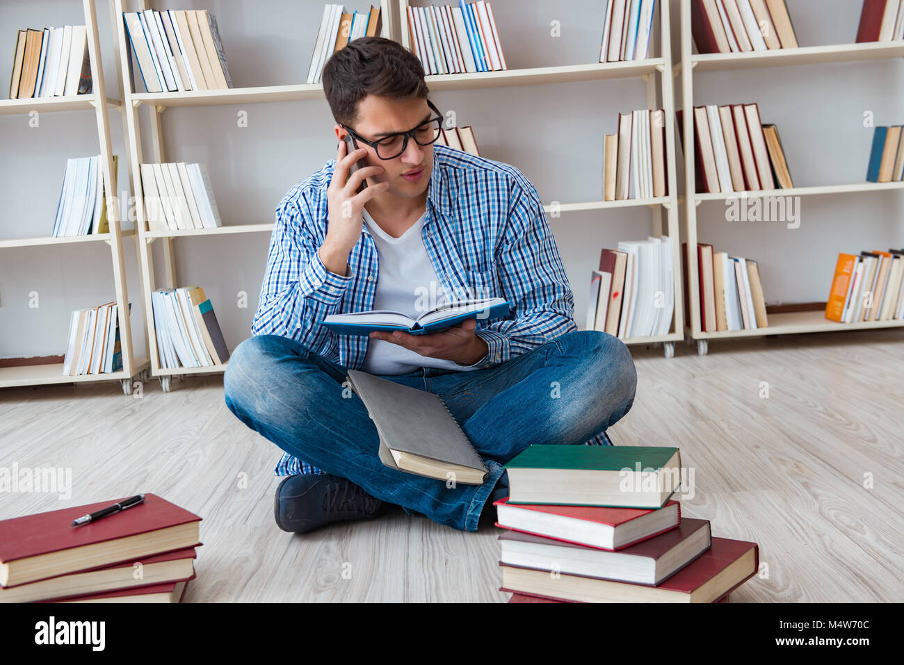 Young student studying with books Stock Photo - Alamy