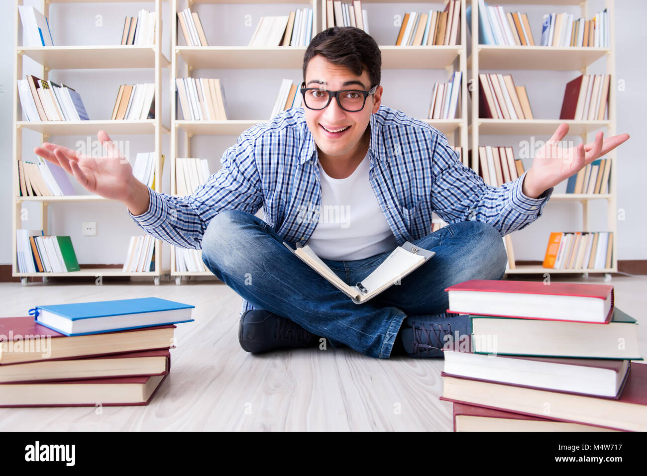 Young student studying with books Stock Photo - Alamy