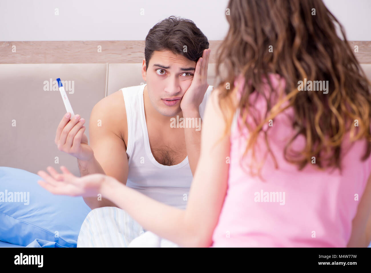 Young family with pregnancy test results Stock Photo - Alamy