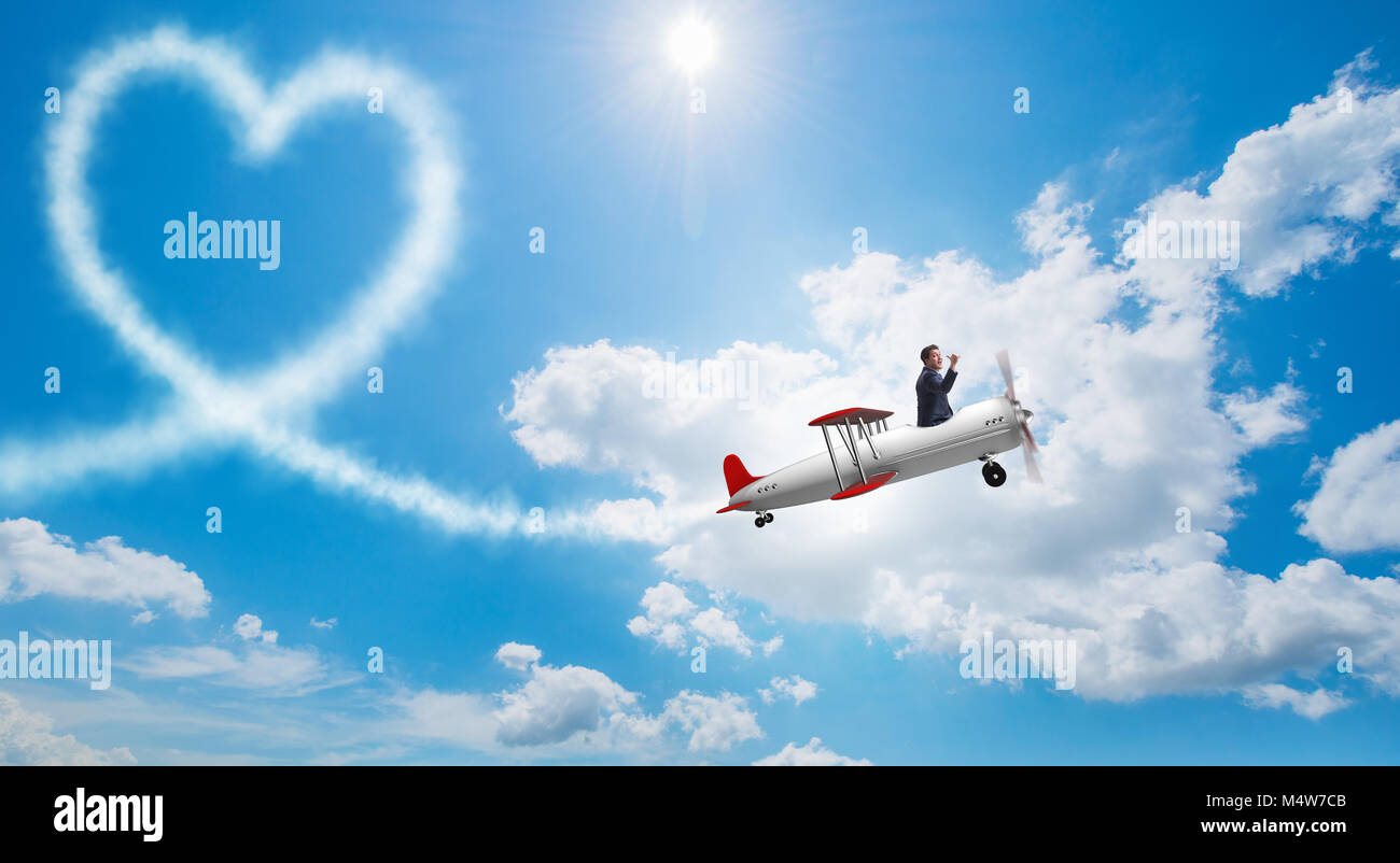 Man flying airplane and making heart shape Stock Photo - Alamy